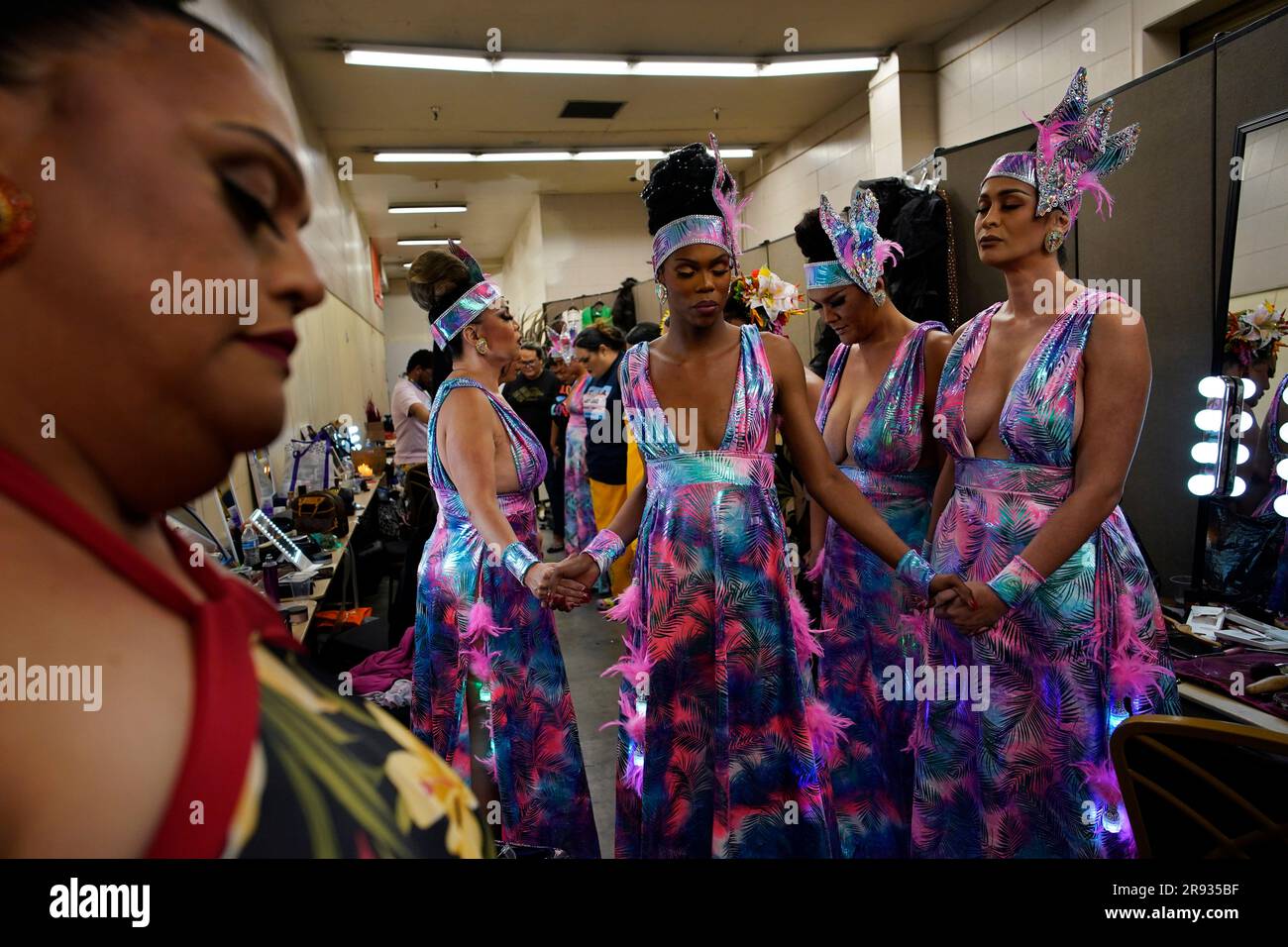 Performers, including Chevis Regal, center, hold hands before ...