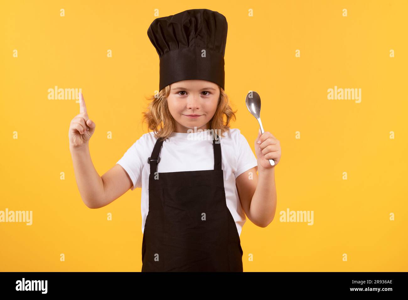 Cute kid boy cook with cooking spoon. Child wearing cooker uniform and ...