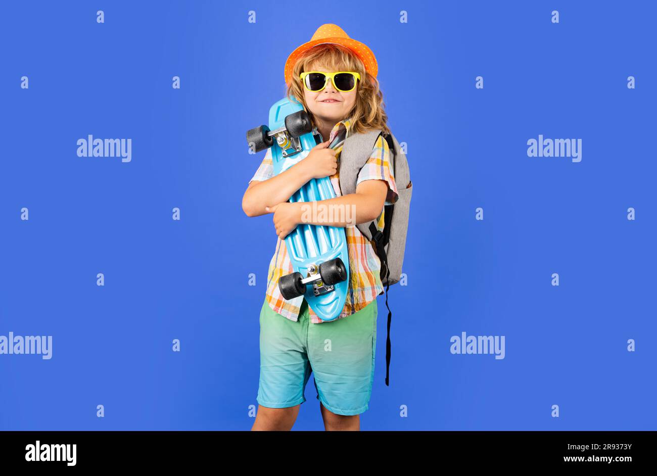 Child with skateboard in the studio. Kid having fun with penny board ...
