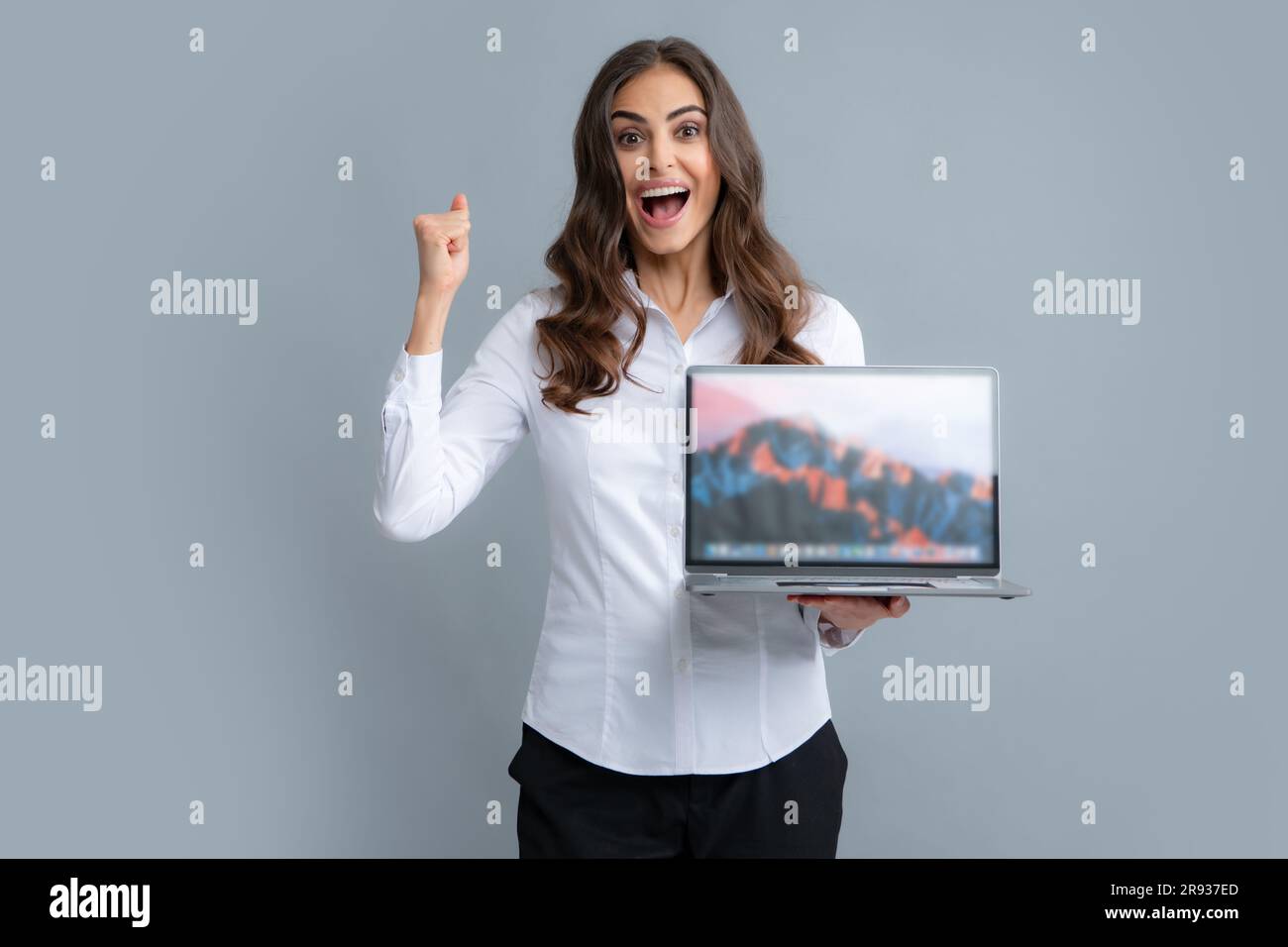 Portrait of a cheerful young casual girl standing isolated over gray ... Portrait of a cheerful young casual girl standing isolated over gray ...