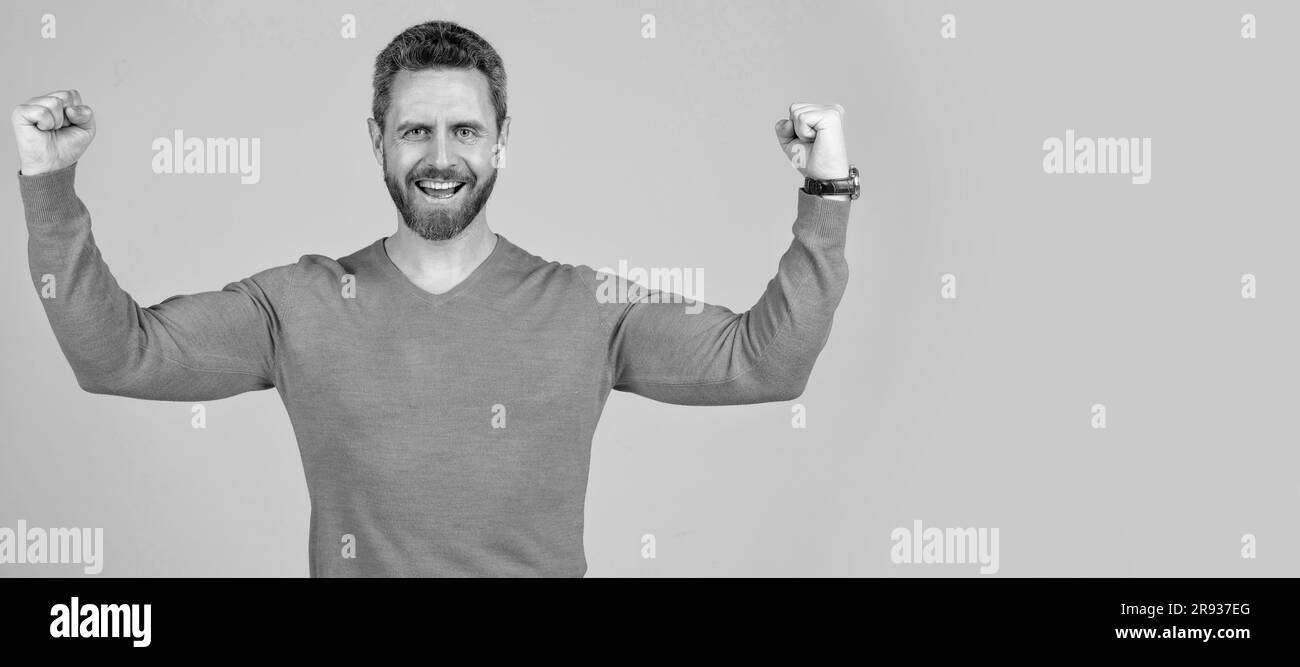 happy mature man with beard show power on grey background, strength ...