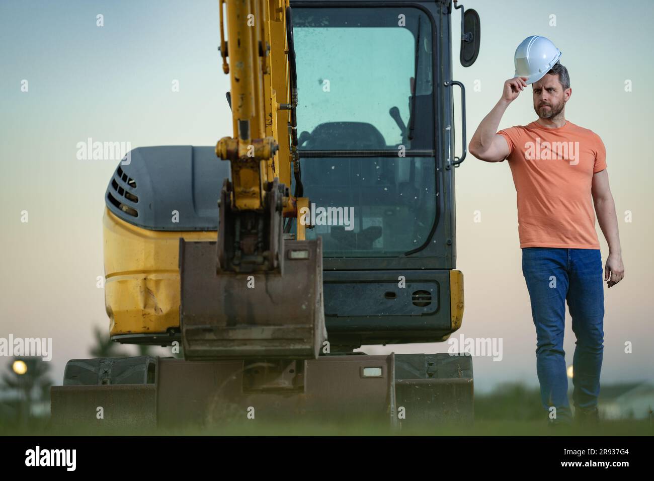 Worker with bulldozer on site construction. Man excavator worker ...