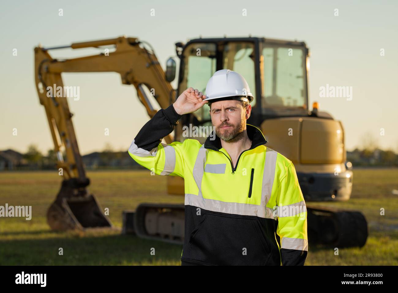 Builder in helmet on the construction site Stock Photo - Alamy