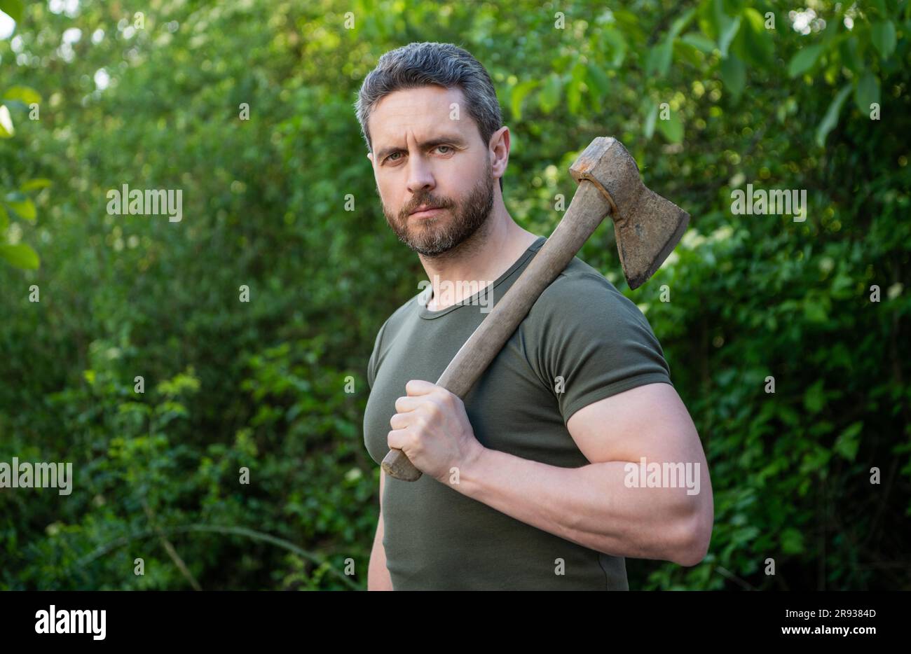 man holding axe outdoor. photo of man with axe. man with axe. man with ...