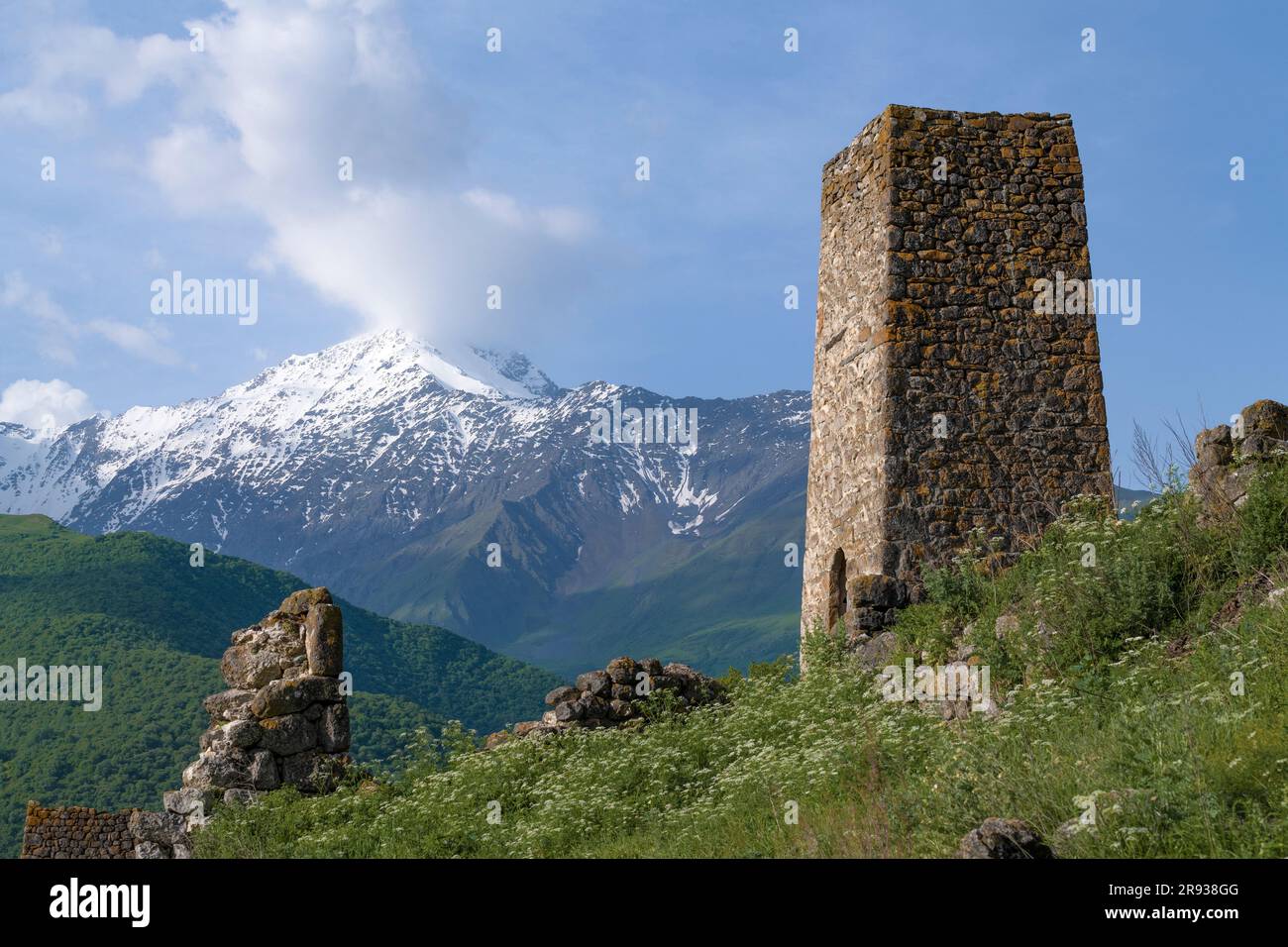 Ancient Ossetian battle tower in the Caucasus mountains on a sunny June ...