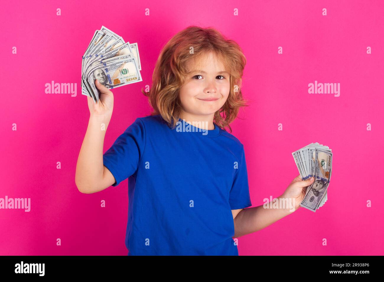 Portrait of a child with money dollars banknotes isolated over studio ...