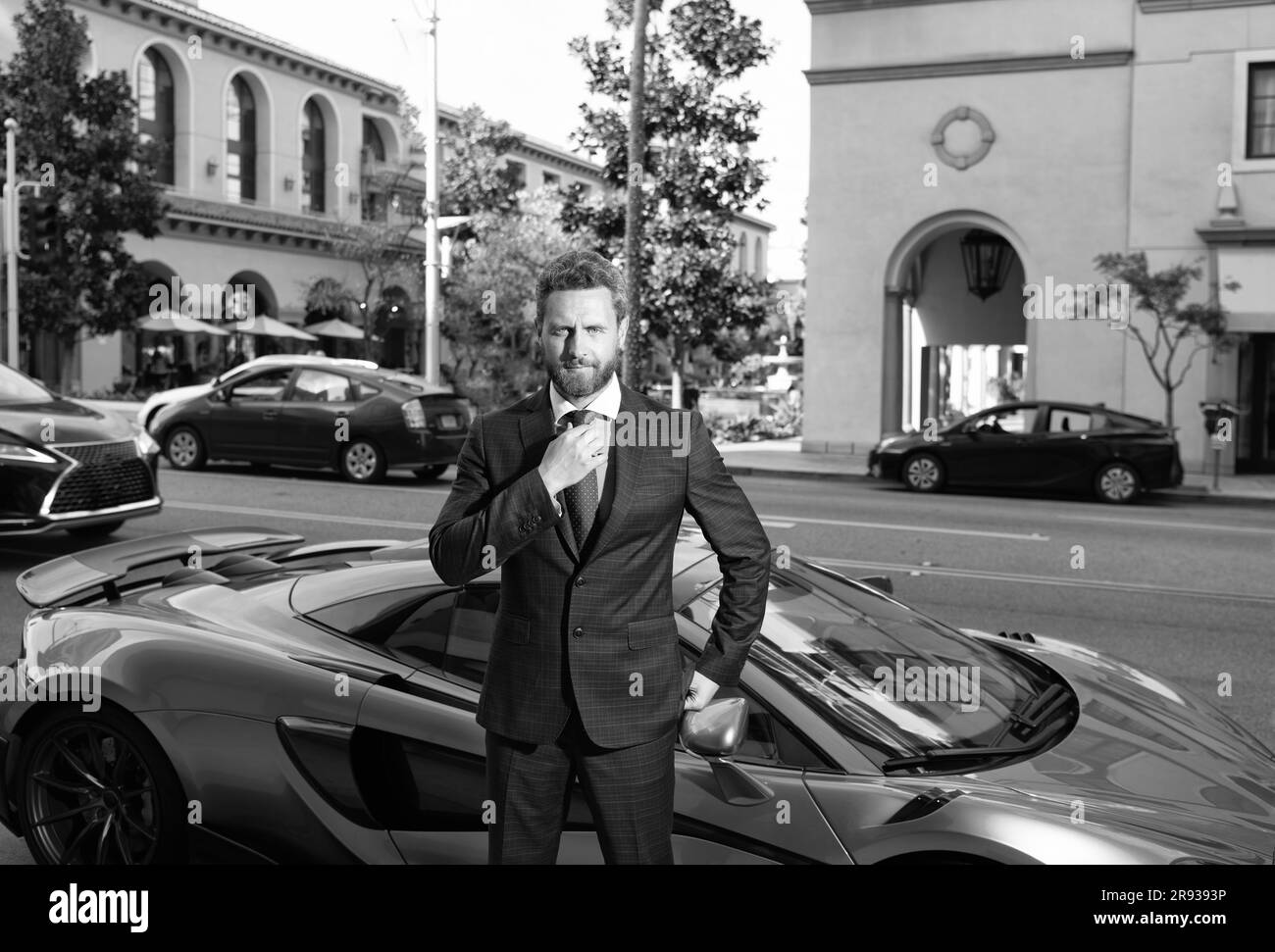 Man stand expensive car Black and White Stock Photos & Images - Alamy