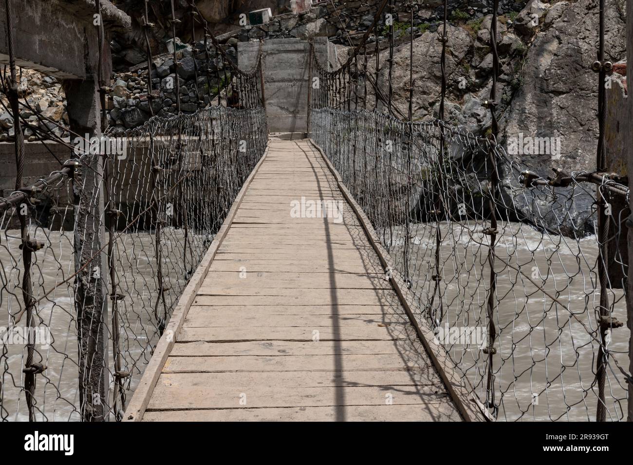 Suspension bridge made of wood and steel ropes over the river swat at ...