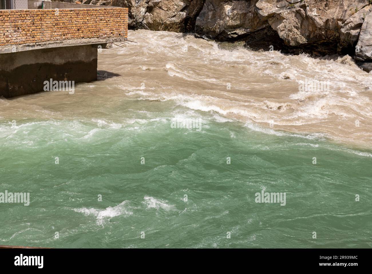 A meeting point of a muddy brown water with a pure green water in the ...