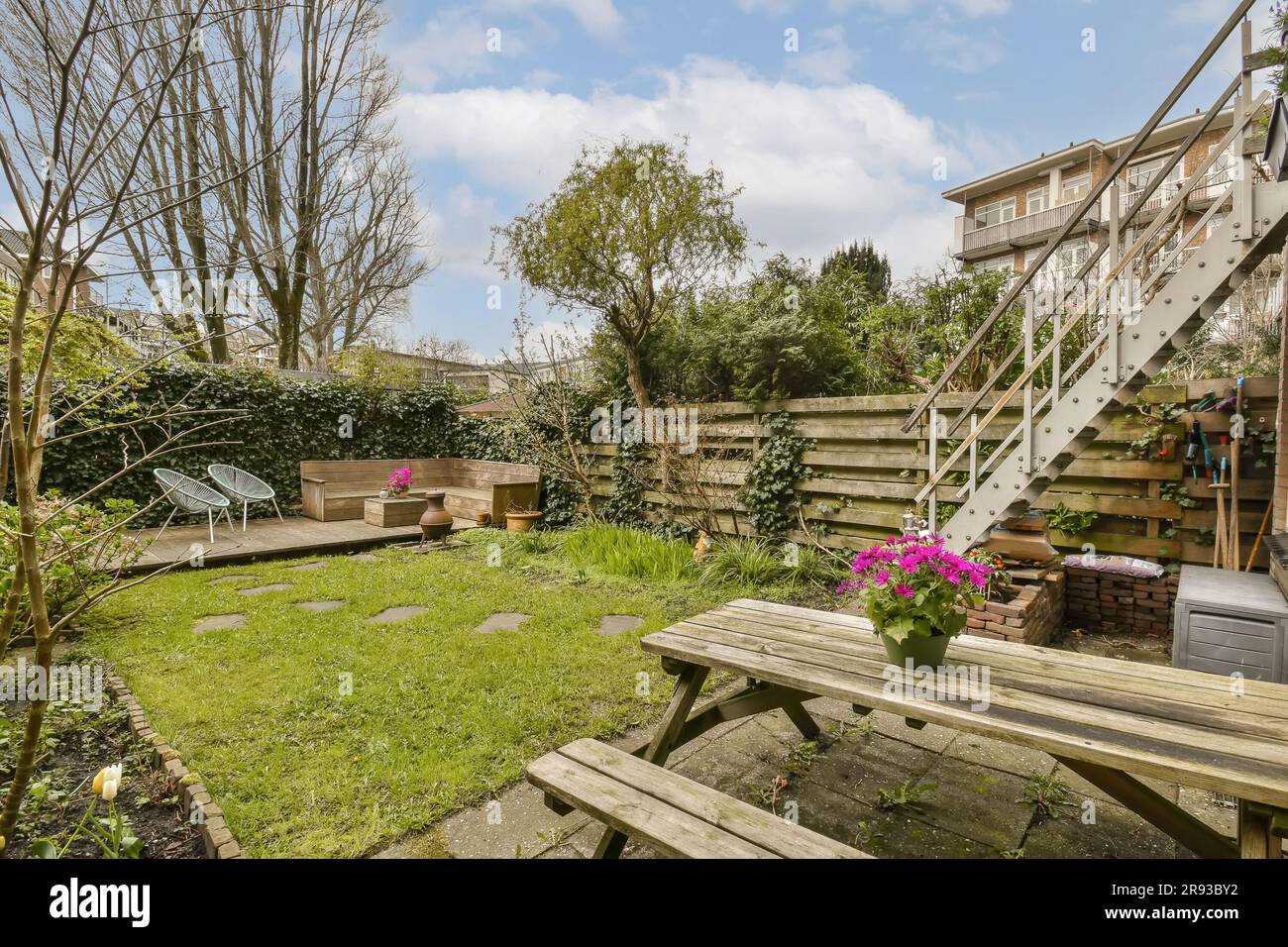 an outdoor garden with wooden benches and plants in the fore - image 2 ...