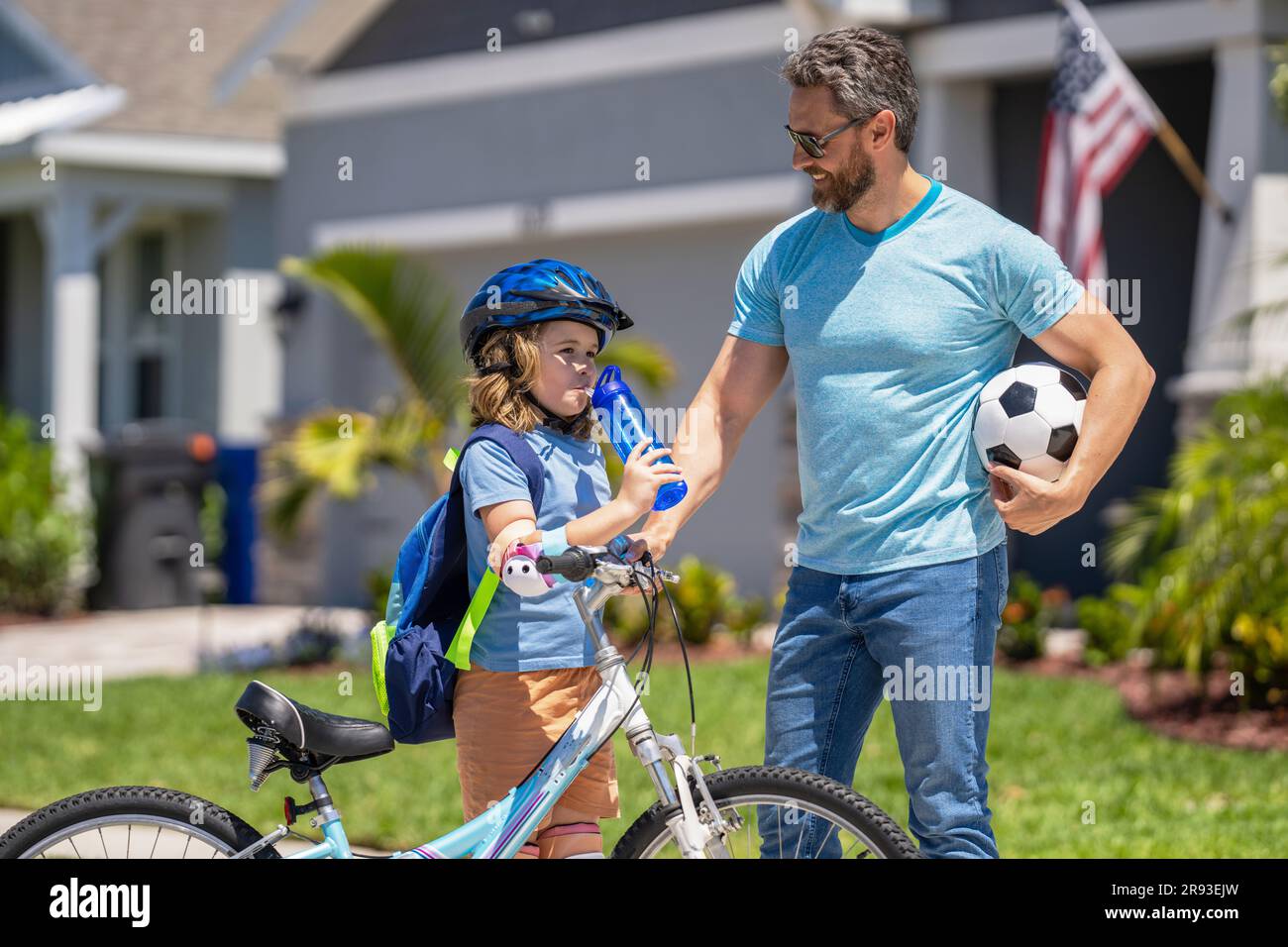 dad and son developing his childhood on bicycle outdoor together Stock ...