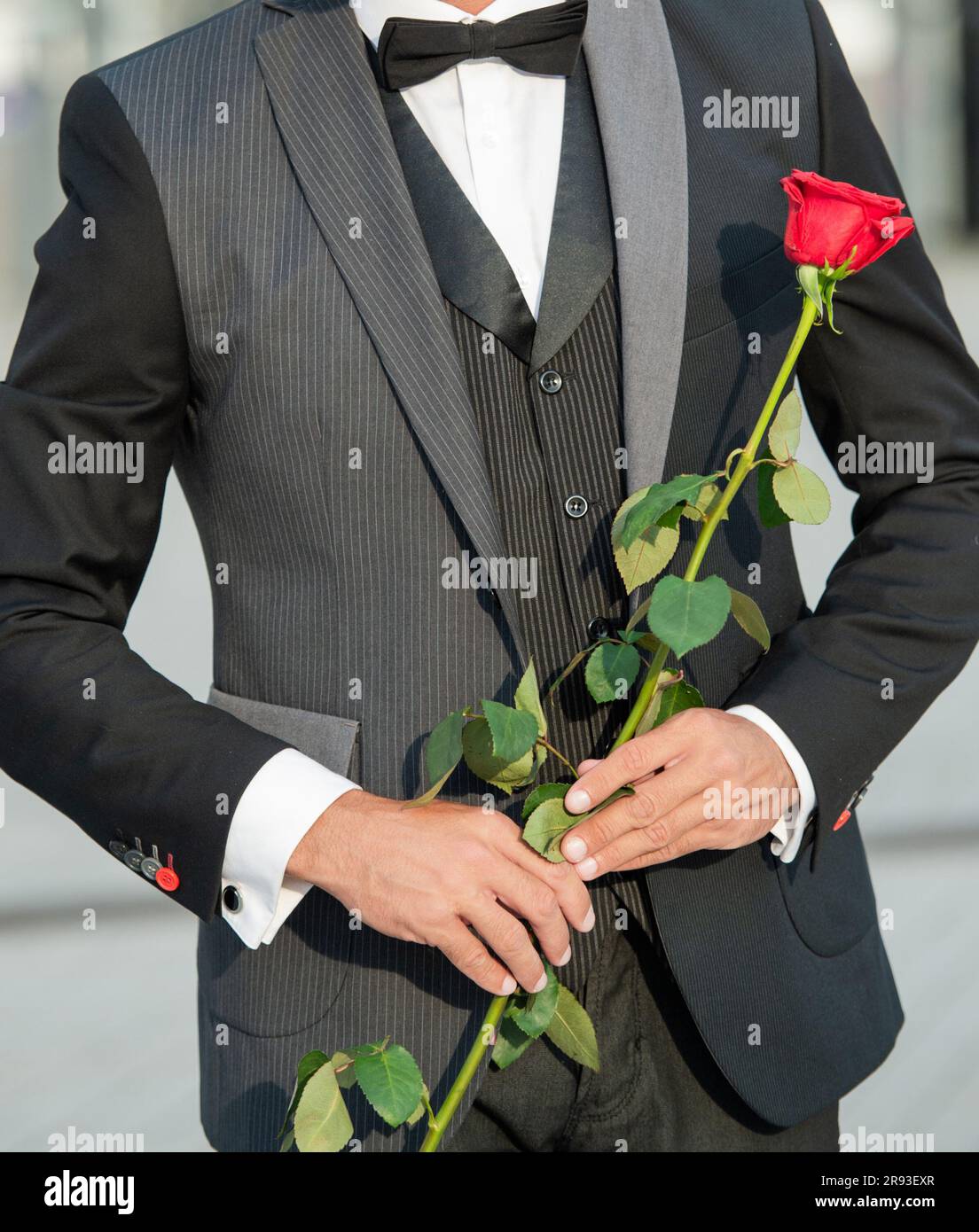 proposal concept. cropped view of black tuxedo man making a proposal ...