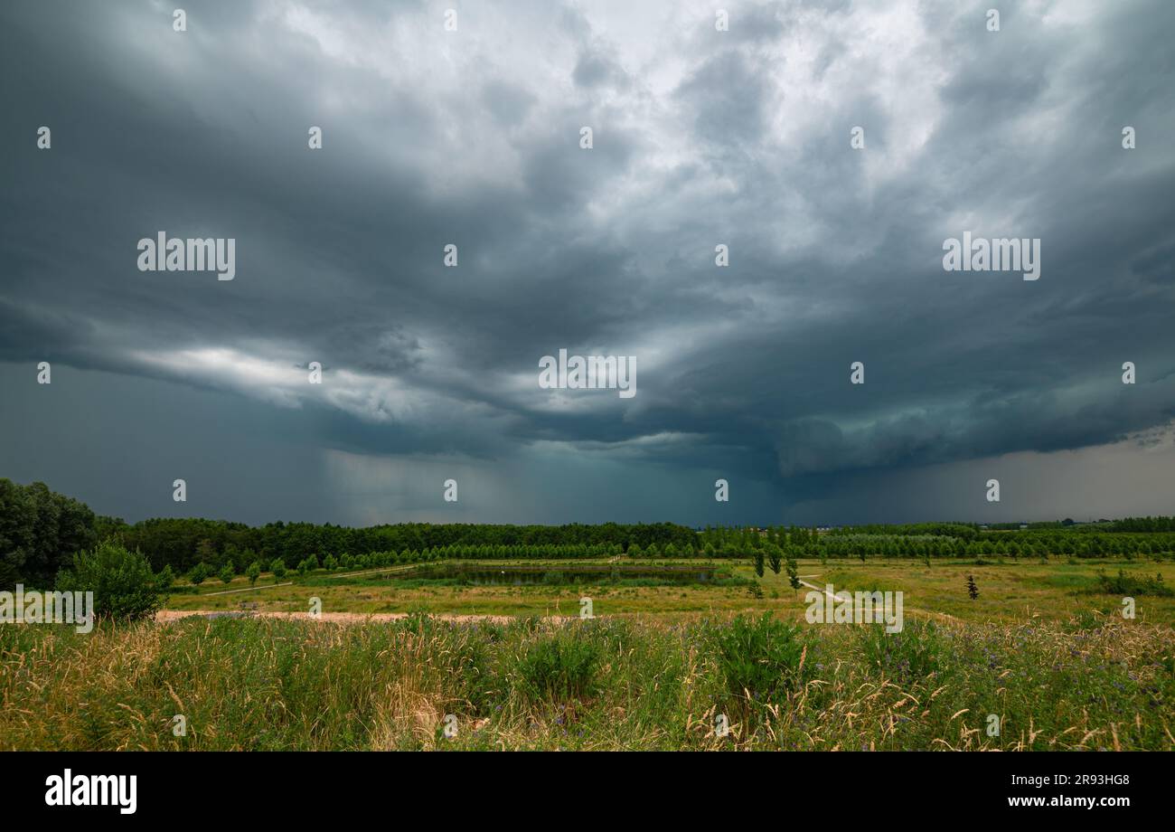 Menacing looking hailstorm with green colors over the flat landscape ...