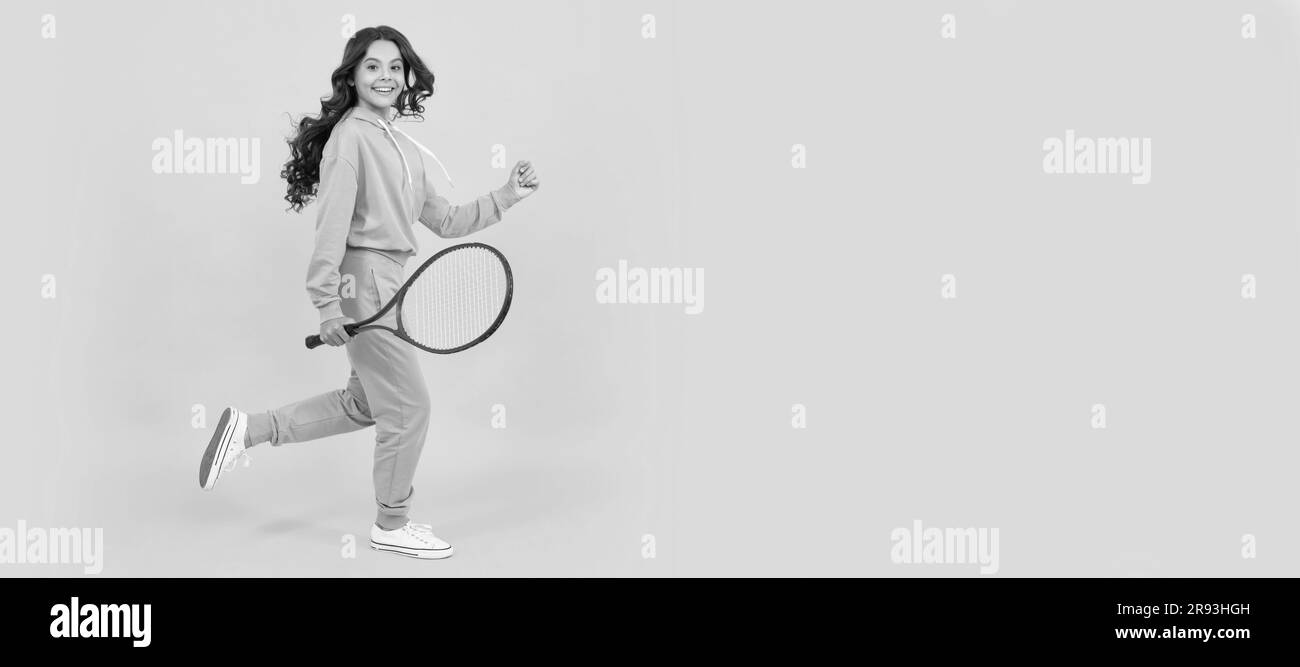 happy energetic kid jump in sportswear with tennis racket running to ...