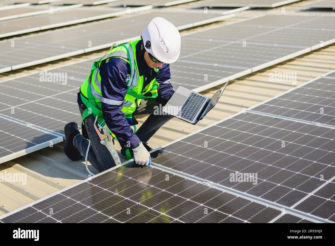 Engineers with safety helmet checking solar system at solar power farm ...