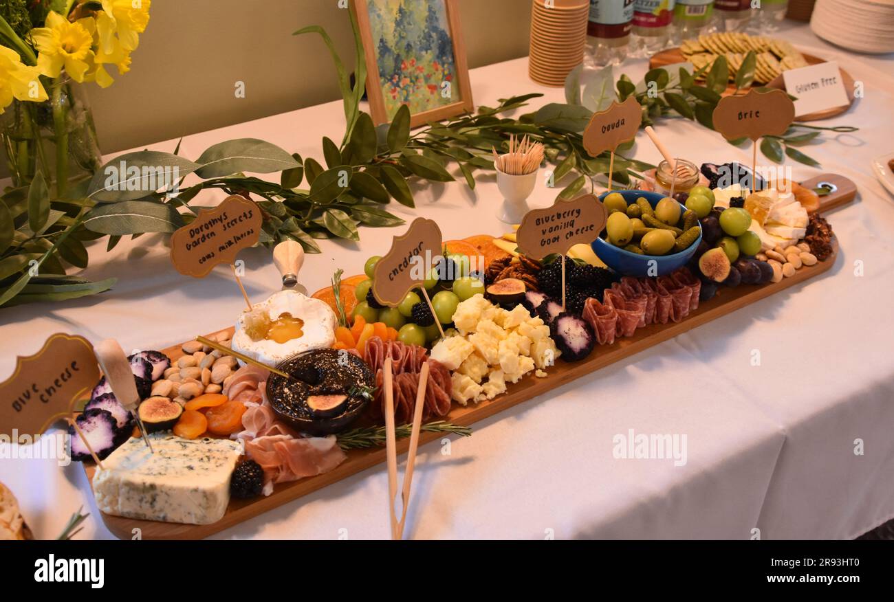 Buffet with a charcuterie board with snacks olives pickles honey and ...
