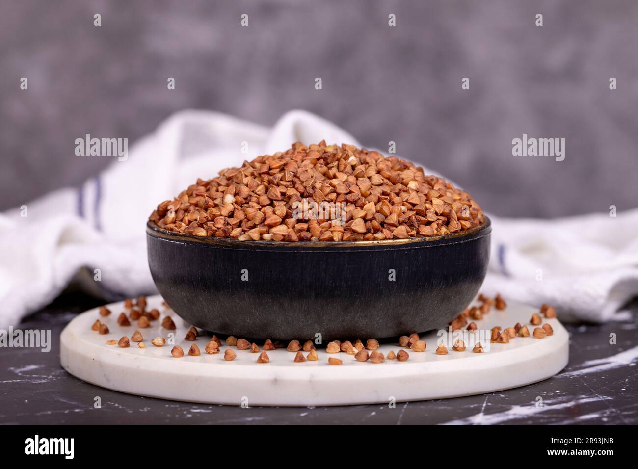 Buckwheat on dark background. Buckwheat grains in bowl Stock Photo - Alamy