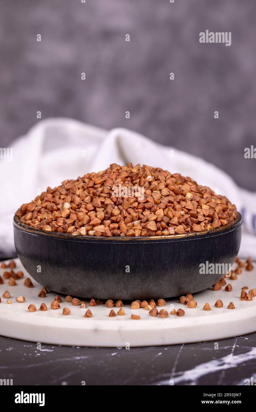 Buckwheat on dark background. Buckwheat grains in bowl Stock Photo - Alamy