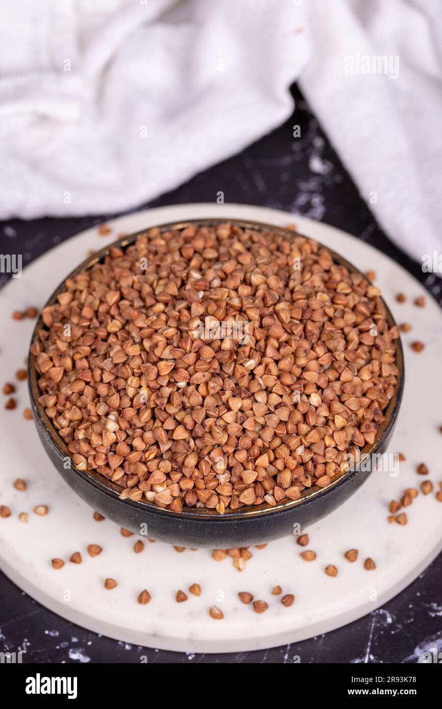 Buckwheat on dark background. Buckwheat grains in bowl Stock Photo - Alamy