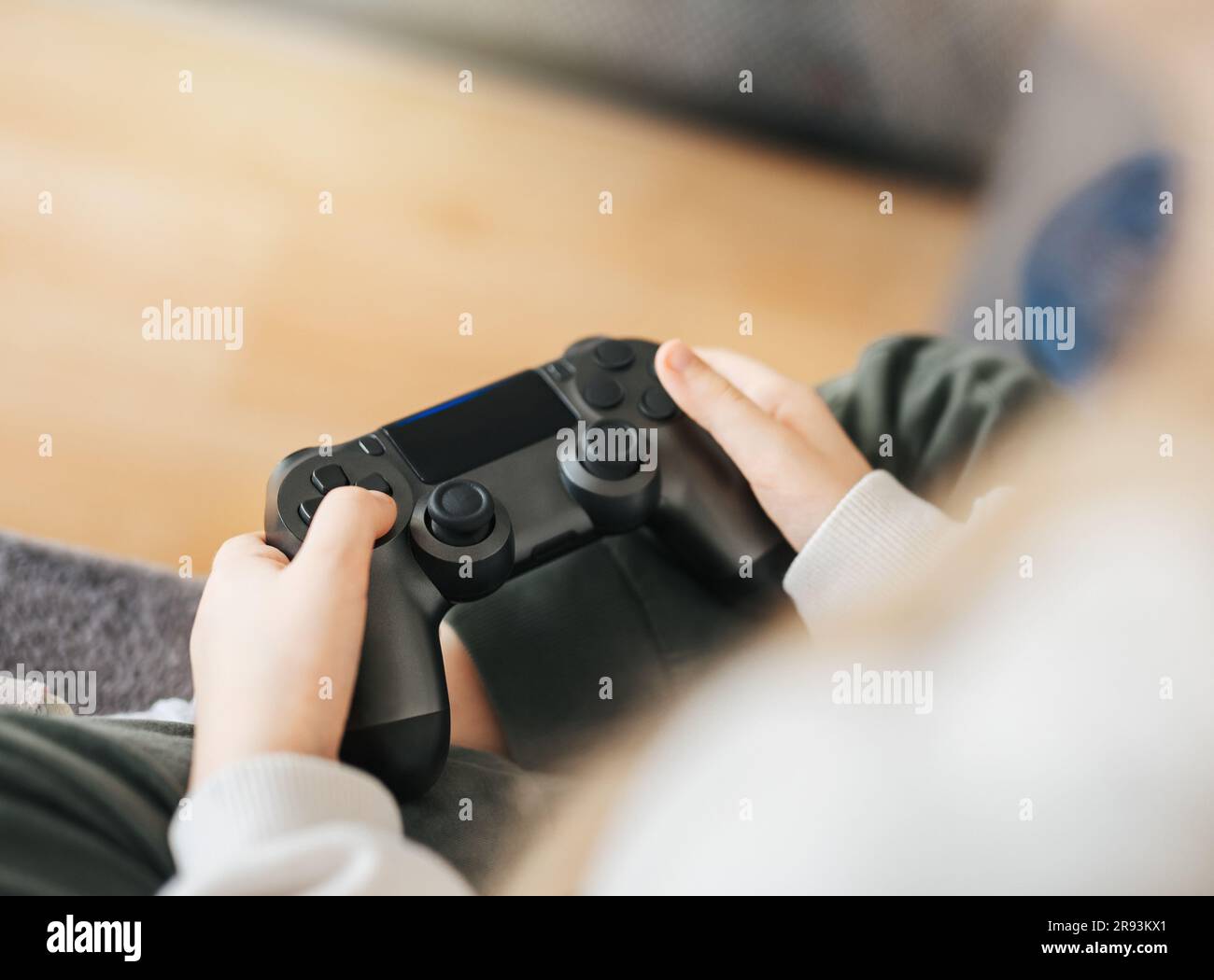 A girl holding game controller playing video games Stock Photo - Alamy