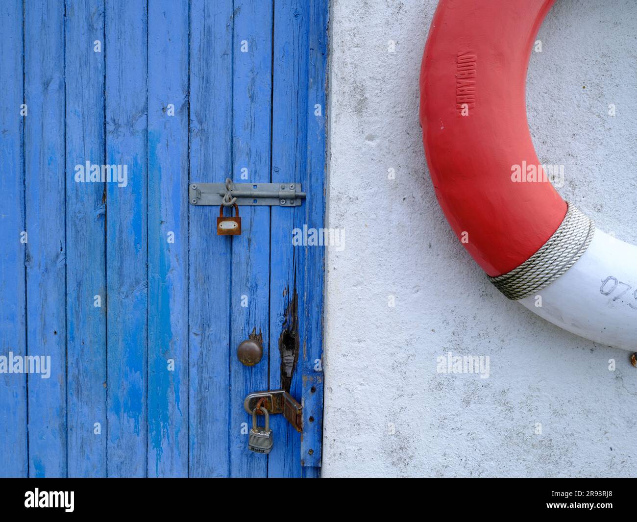 LIFEBUOY AND WEATHERED DISTRESSED BLUE DOOR NEWLYN HARBOUR Stock Photo ...