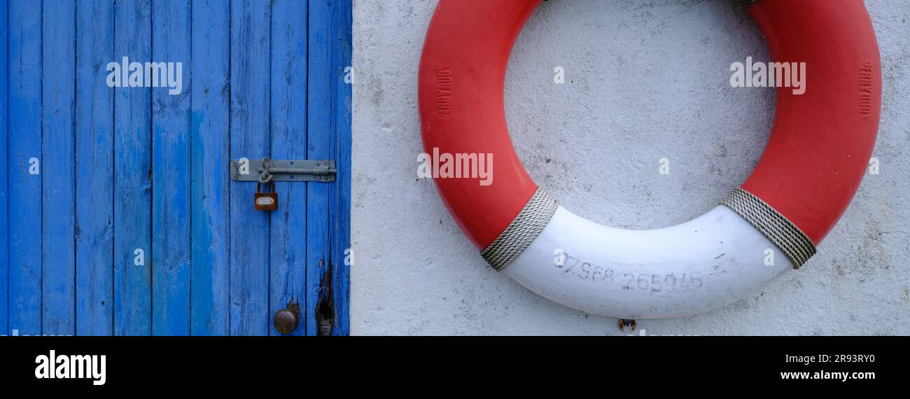 LIFEBUOY AND WEATHERED DISTRESSED BLUE DOOR NEWLYN HARBOUR Stock Photo ...