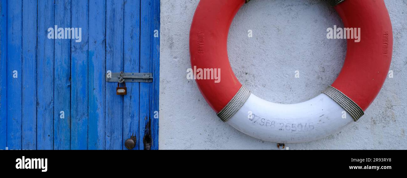 LIFEBUOY AND WEATHERED DISTRESSED BLUE DOOR NEWLYN HARBOUR Stock Photo ...