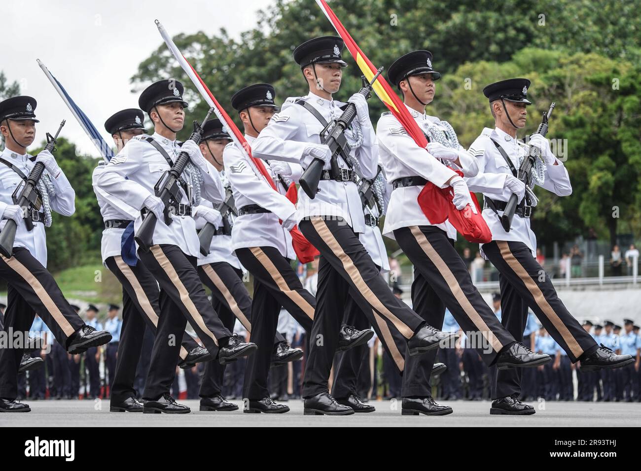 The police officers march with the flags of China and Hong Kong during ...