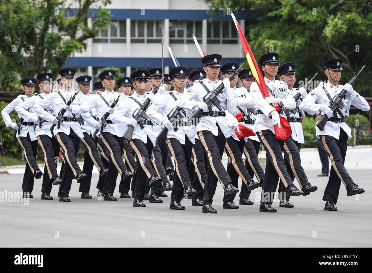 The police officers march with the flags of China and Hong Kong during ...