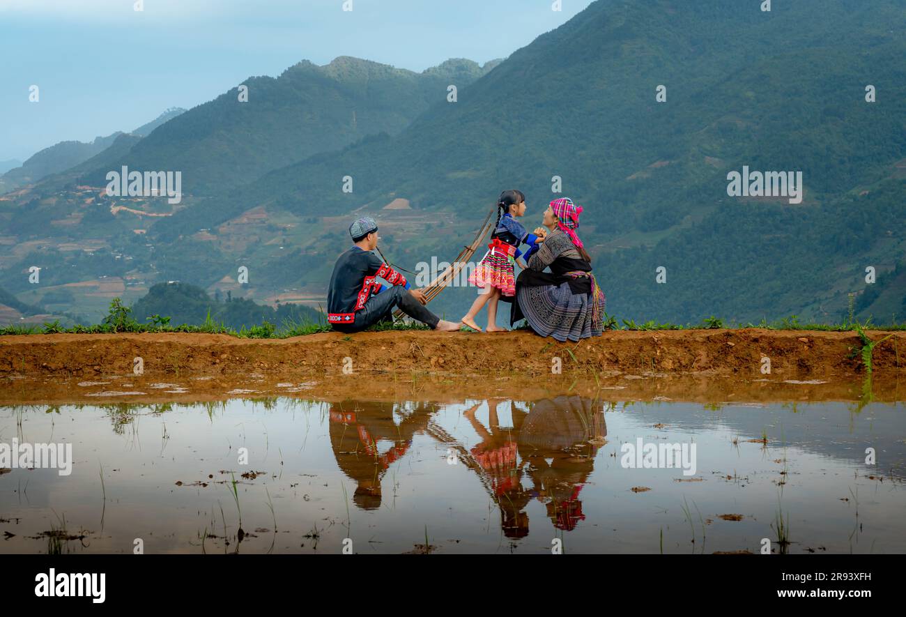 A young H'mong family relaxes by a terraced field in Mu Cang Chai, Yen ...