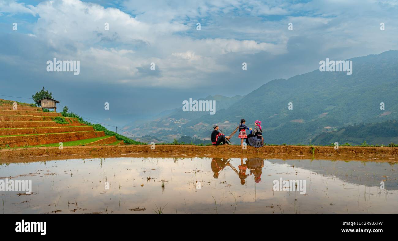A young H'mong family relaxes by a terraced field in Mu Cang Chai, Yen ...
