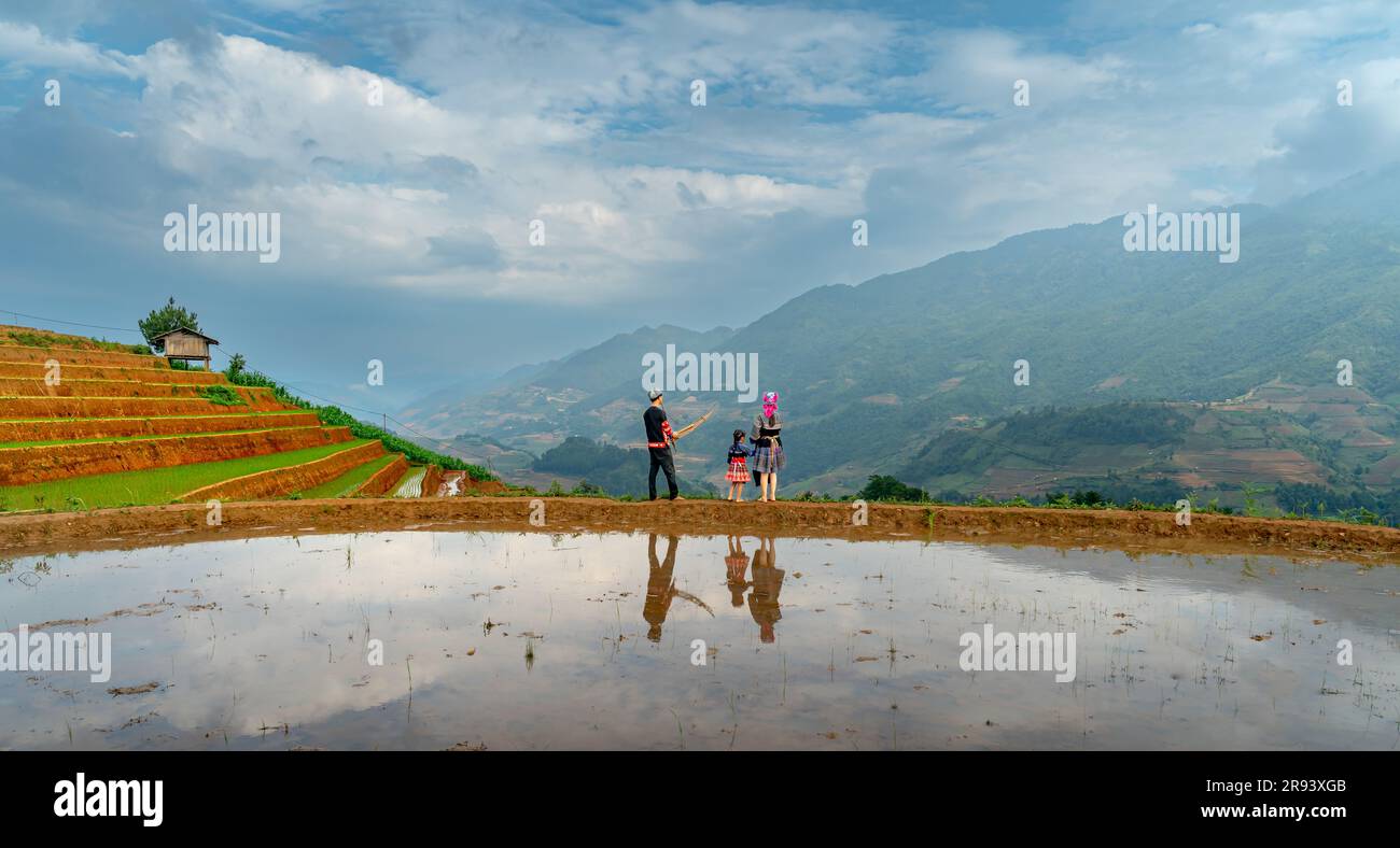 A young H'mong family relaxes by a terraced field in Mu Cang Chai, Yen ...