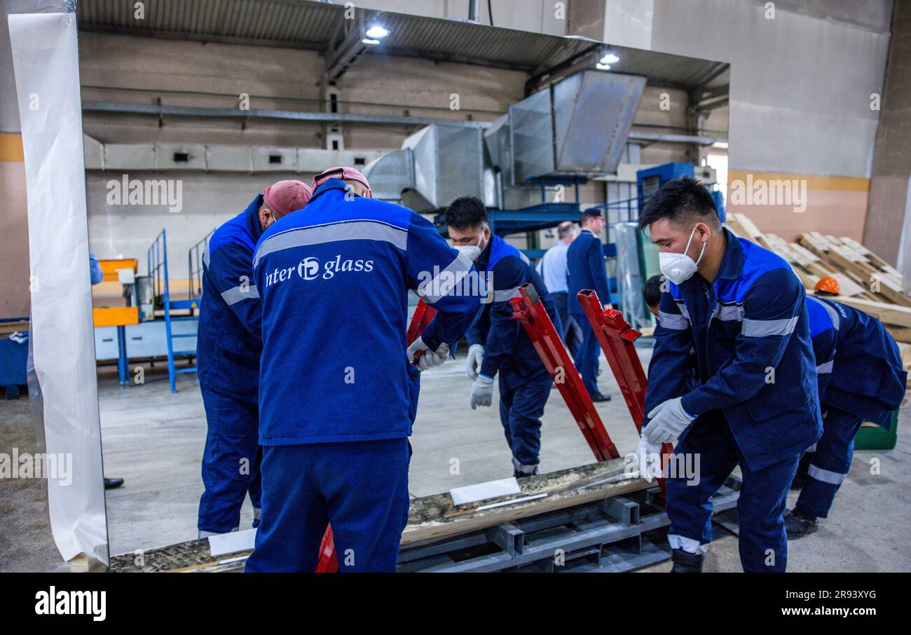 22 June 2023, Kyrgyzstan, Tokmok: Female employees check an employee ...