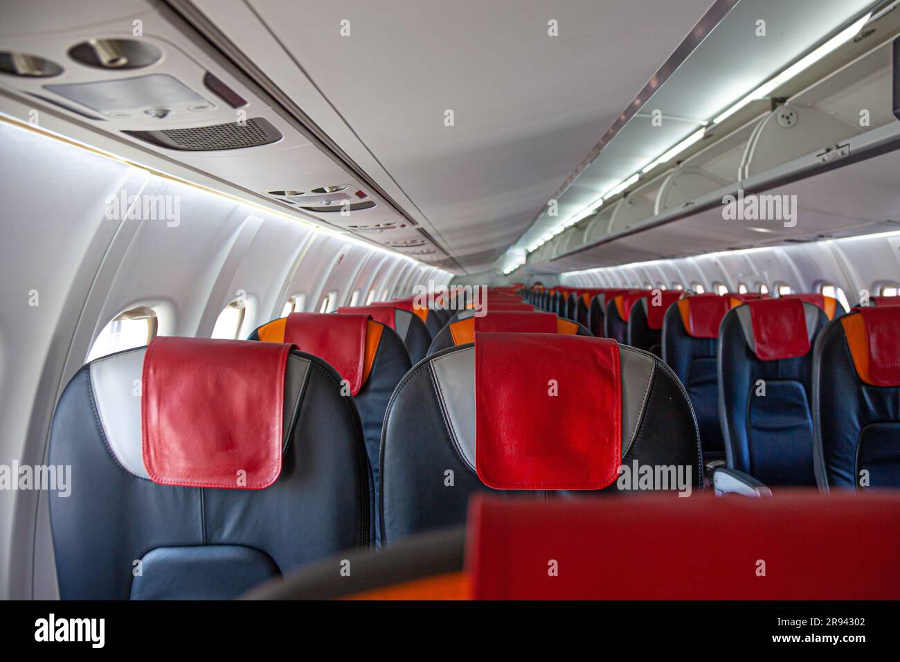 Empty cabin of the plane. Soft seats for passengers, portholes. Inside ...