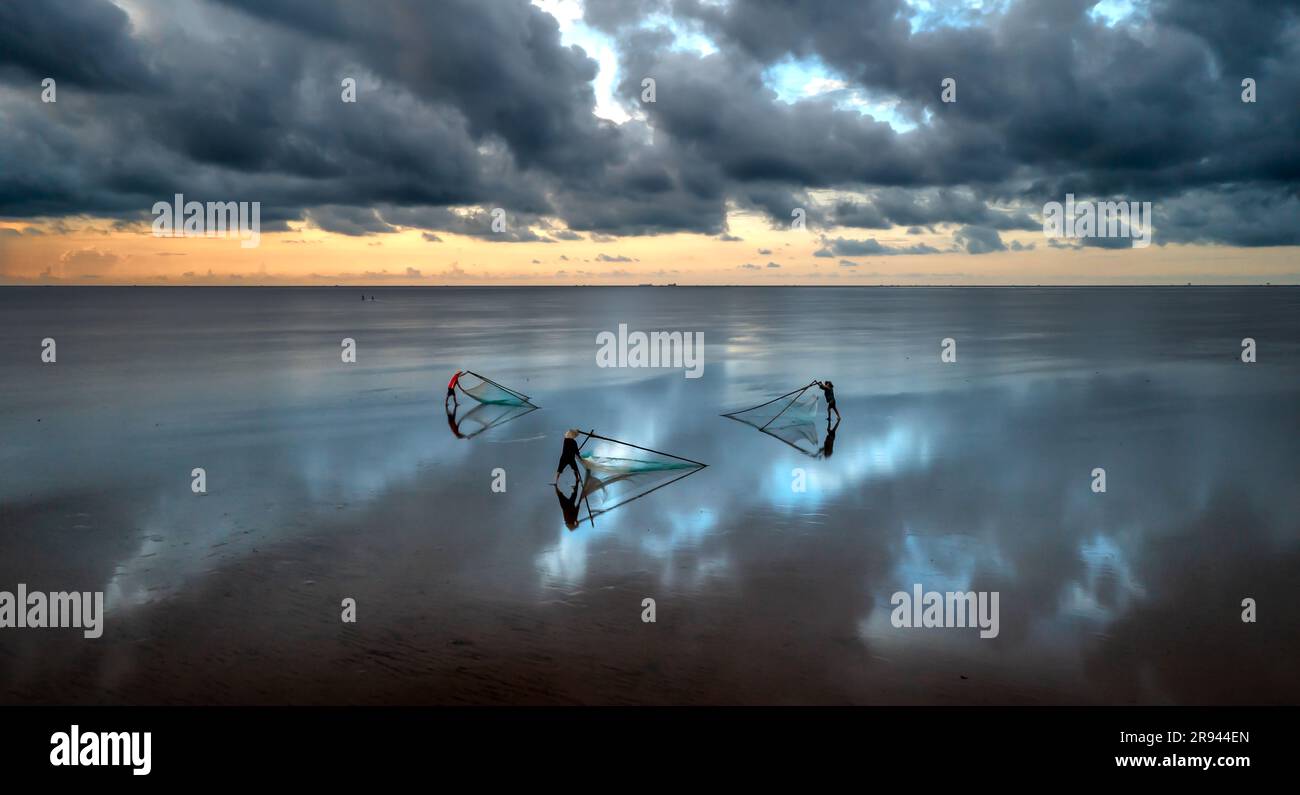 The image of fishermen in the fishing village using homemade tools to ...