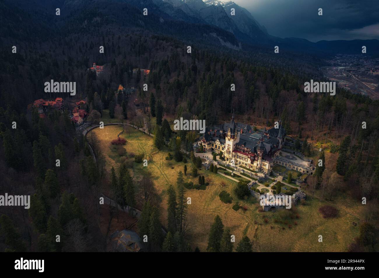 An aerial view of majestic castle surrounded by lush trees and majestic ...