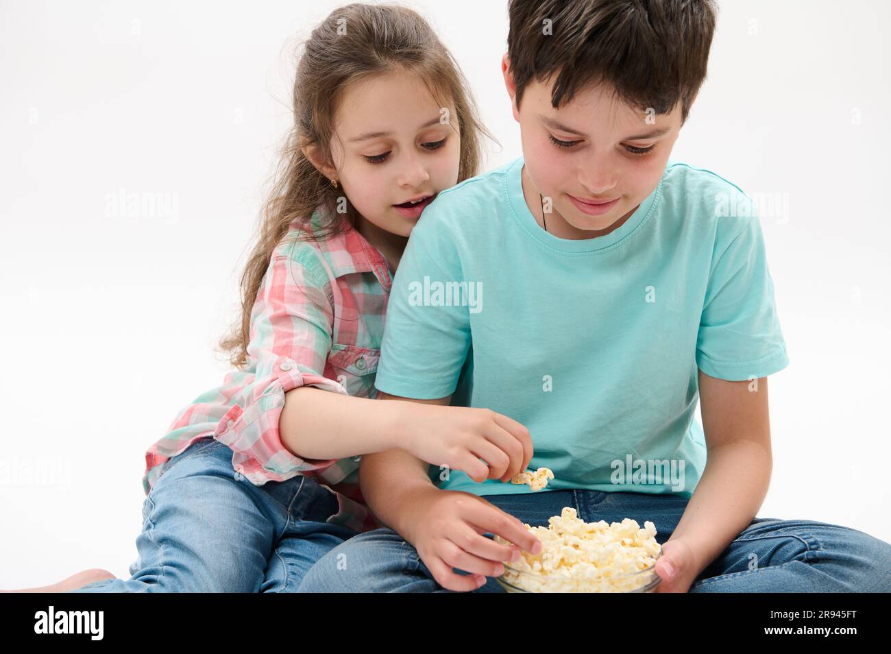 Close-up lovely children kids - preteen boy and cute baby girl eating ...