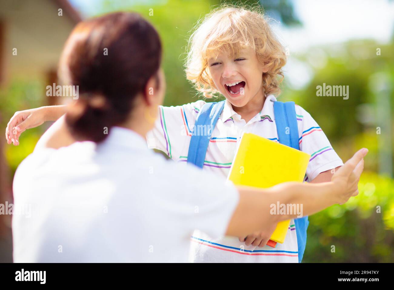 Mother bringing child to school. Parents pick up little boy after class ...