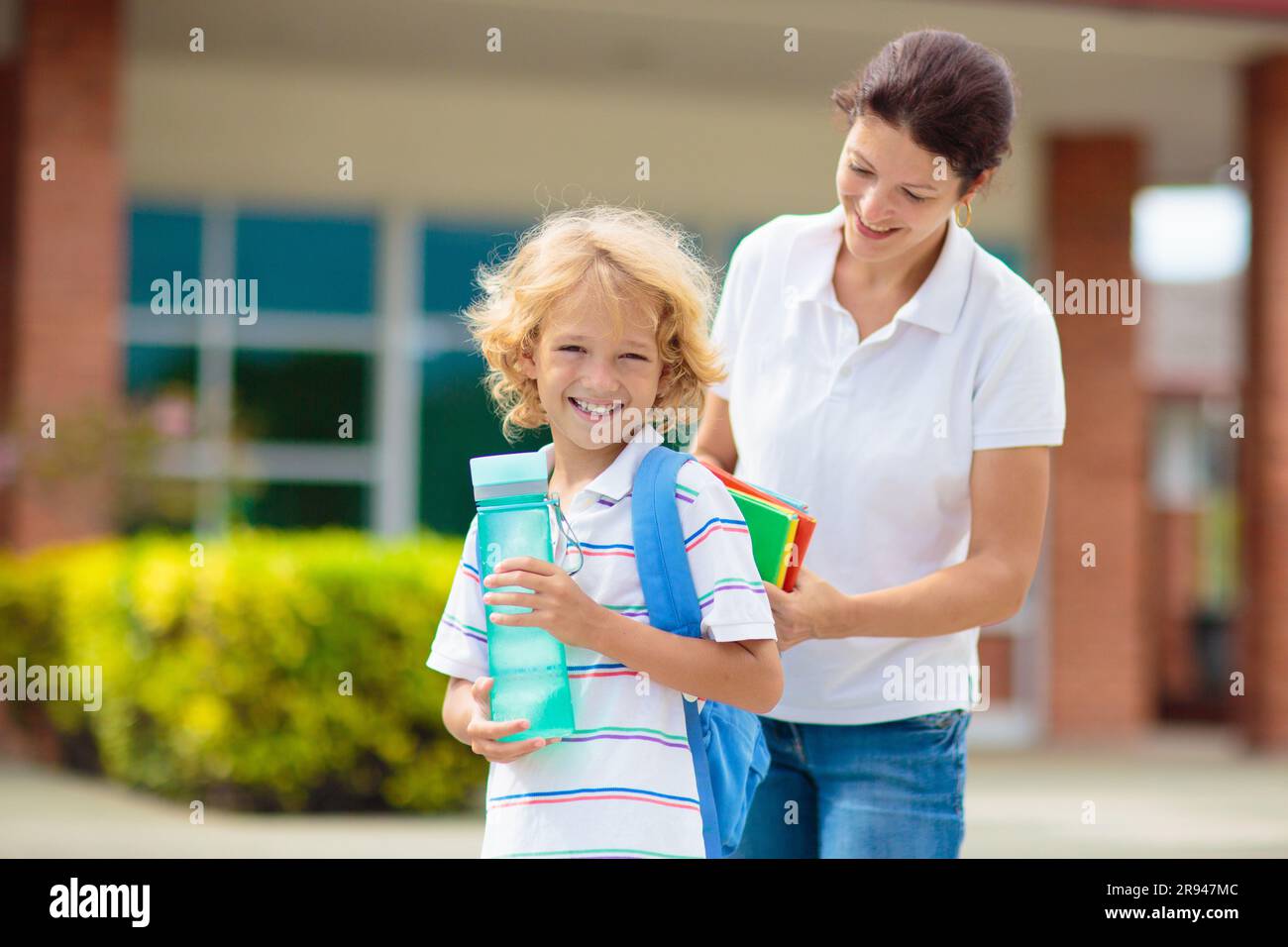 Mother bringing child to school. Parents pick up little boy after class ...