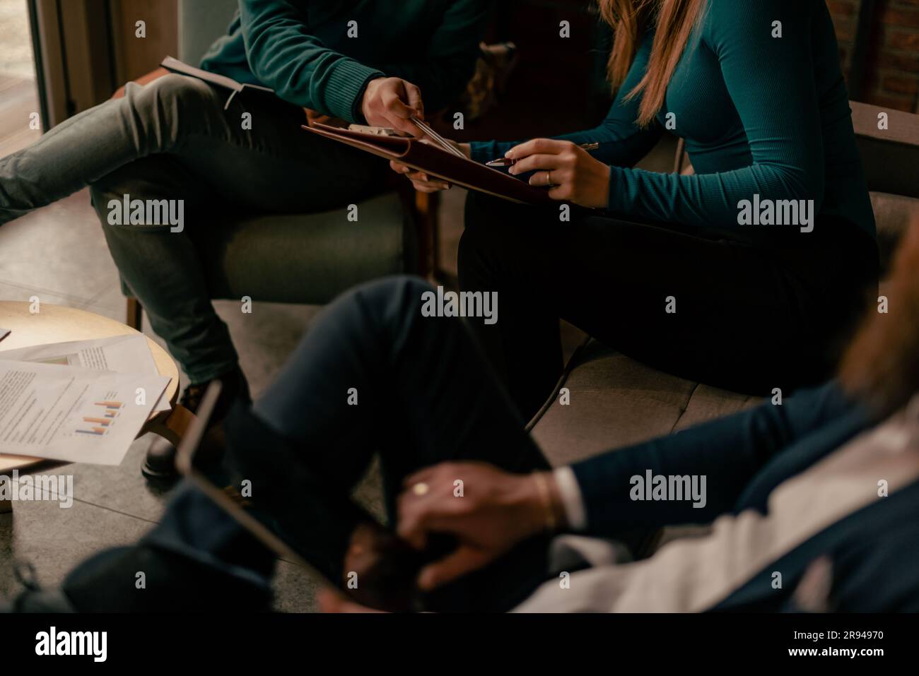 Close up shot of male person helping his female coworker with her daily ...