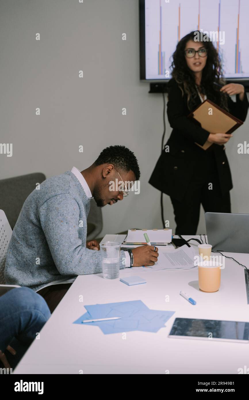 A handsome black male business person underlining most important parts ...