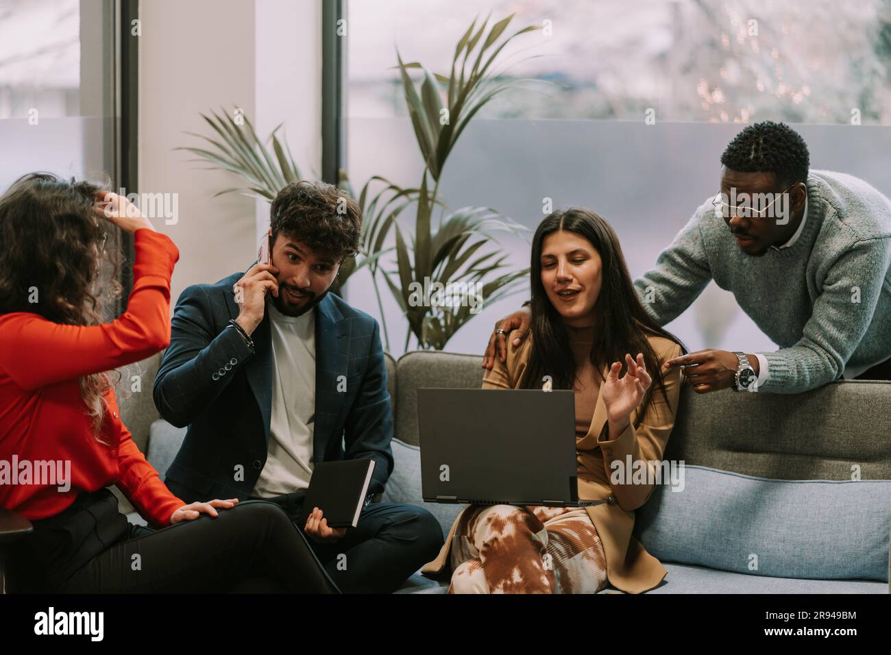 Two multiracial couples working together at the office. Black male ...