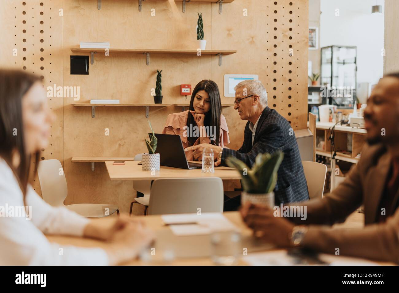 70s experienced company leader explaining new business idea to his ...