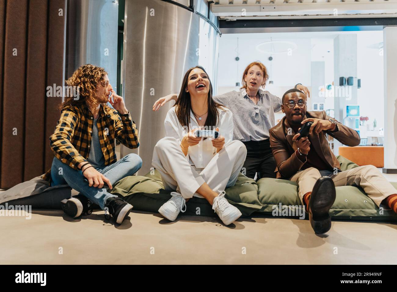 A shot of multiracial colleagues, male and female, playing electronic ...