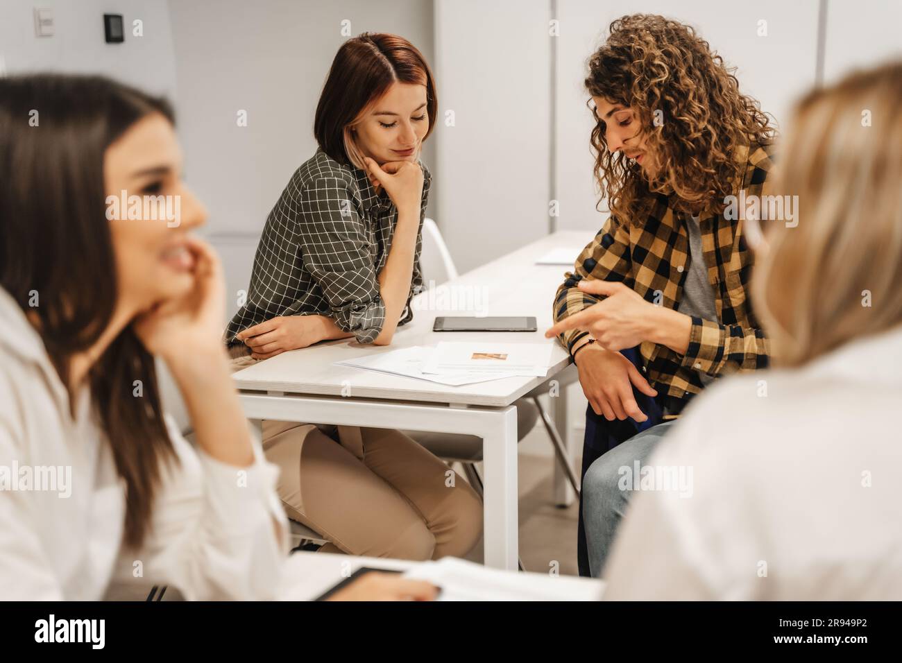 Beautiful girl with slight smile on the face listening carefully to her ...