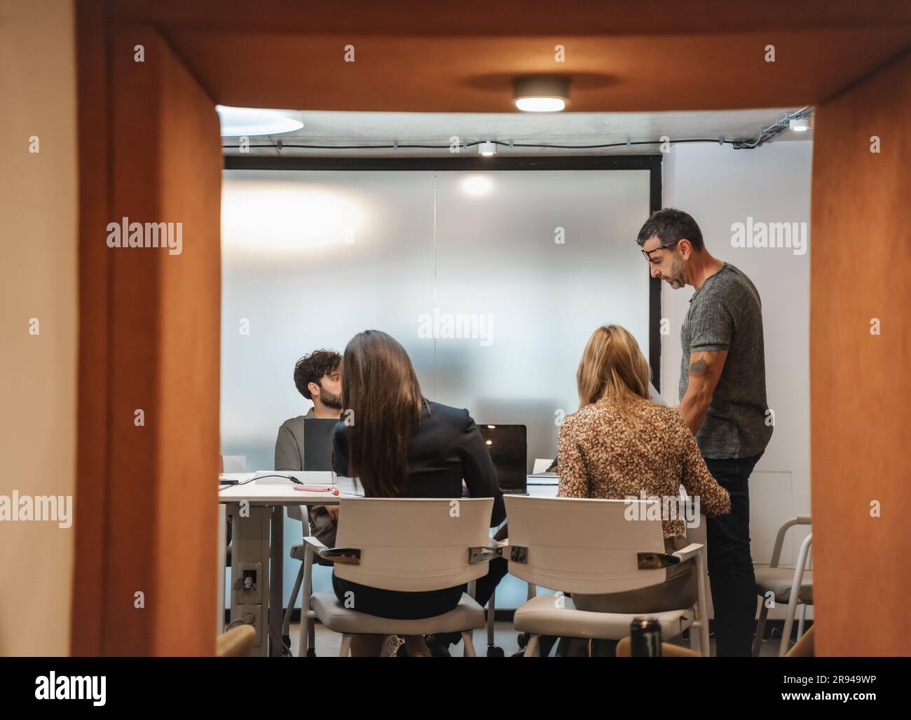 Side view shot of middle-aged company boss getting ready to talk to his ...