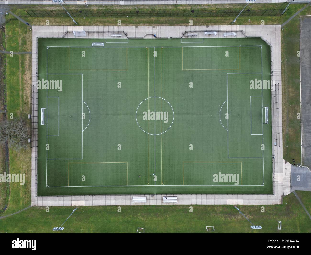 An aerial view of an outdoor football field, illuminated by natural ...