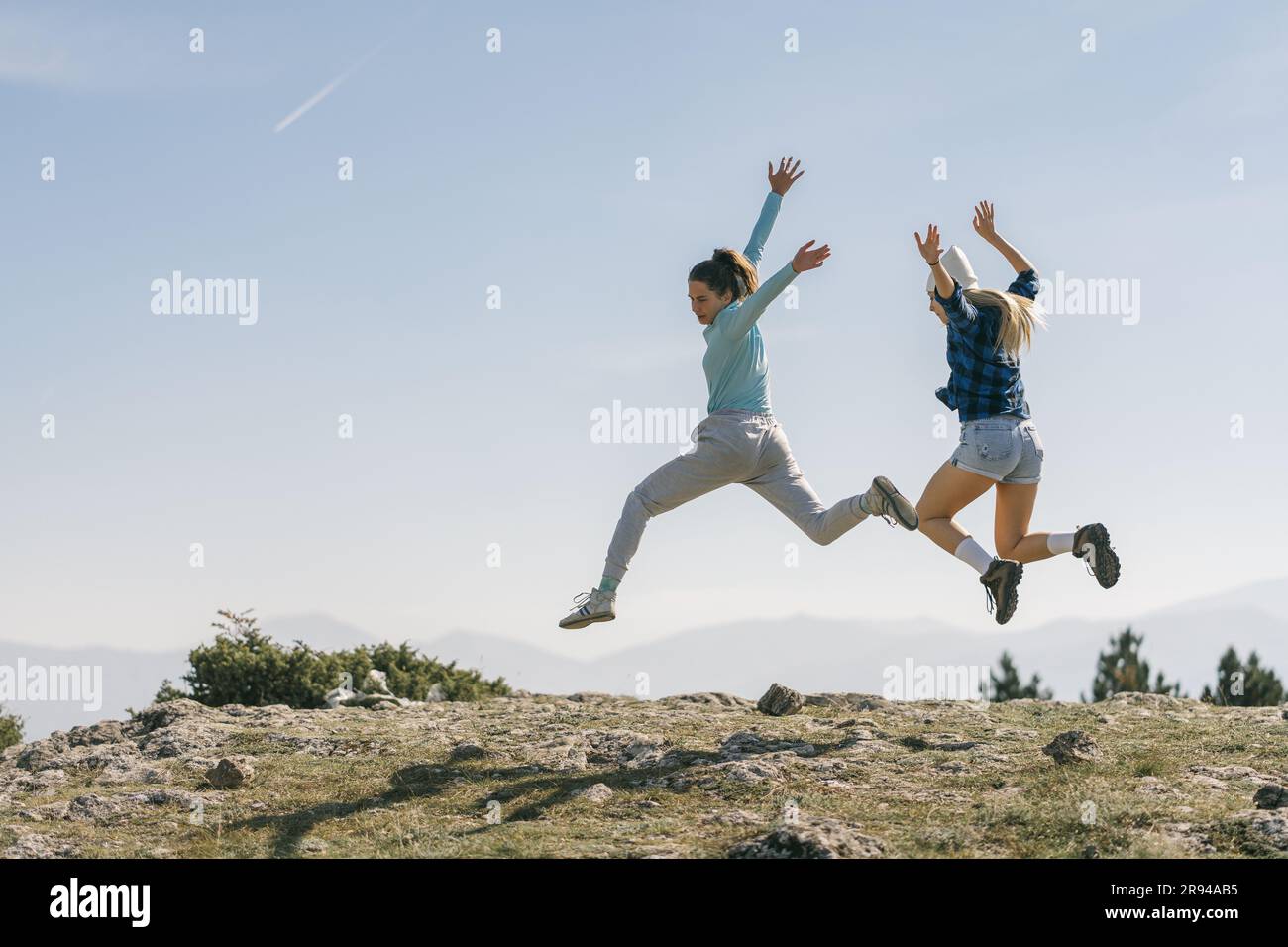 Female hikers having fun on top of the mountains. They are happy and ...