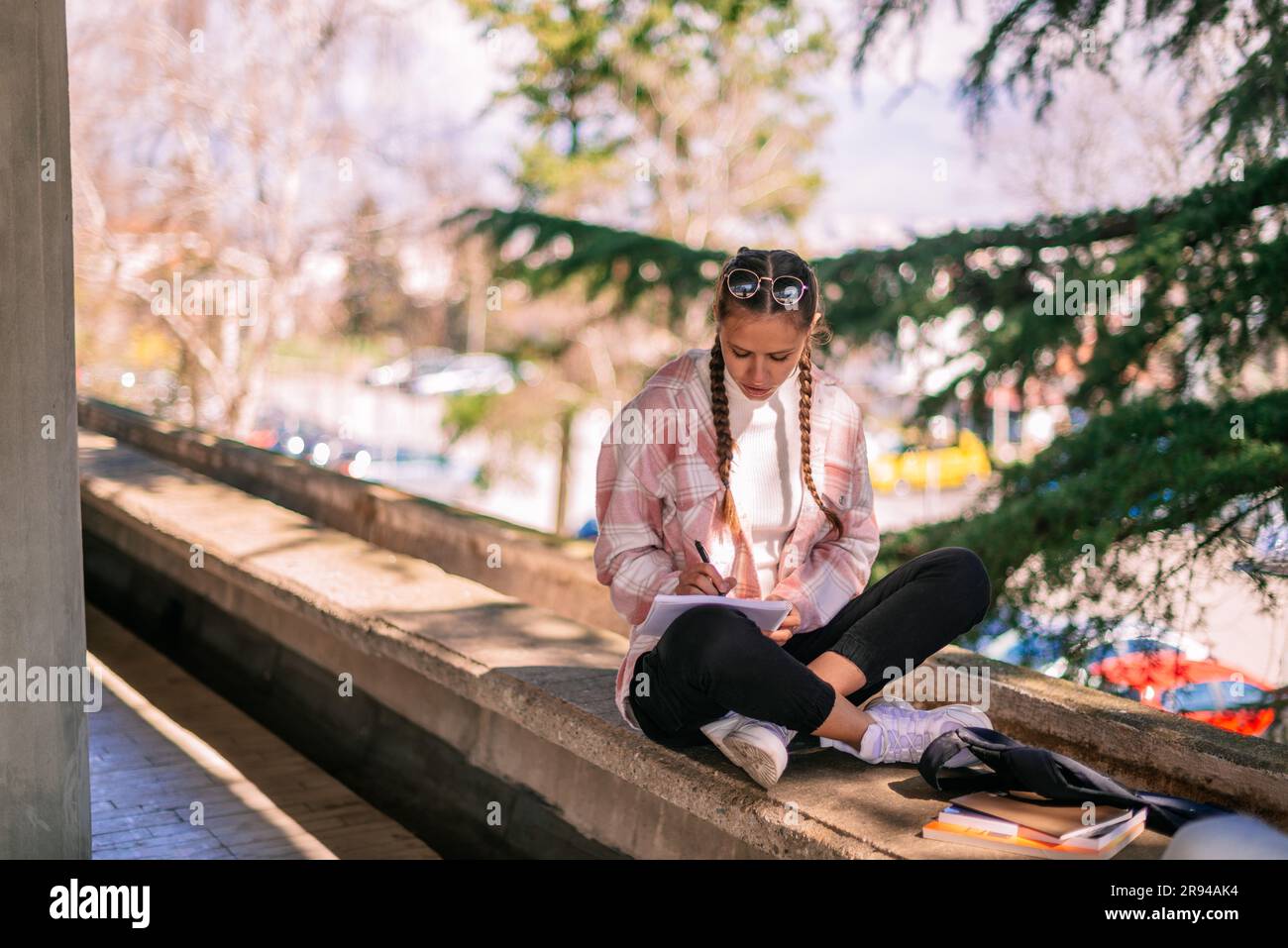 Front view shot of brunette girl writing in notebook. Copy space Stock ...