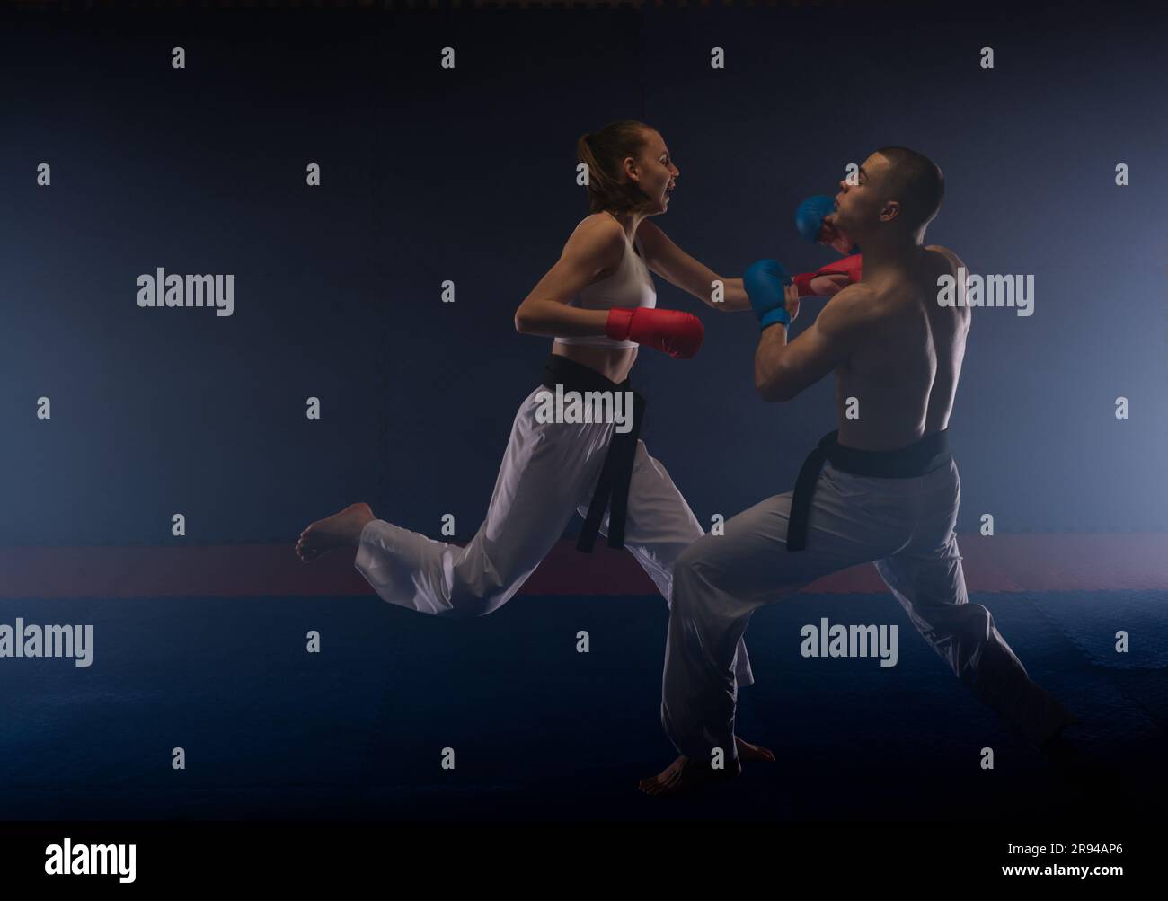 Two young and strong karate kids fighting with their red and blue ...